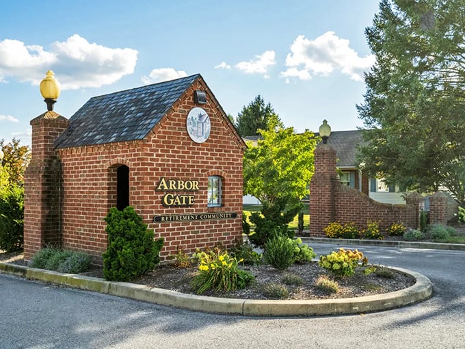 The entrance says it all – brick, brass, and blooms. Like the gatekeeper to a retirement community that actually delivers on its promises.