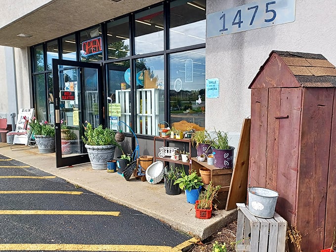 The entrance beckons with rustic charm – galvanized buckets, garden tools, and that weathered barn door practically whispering "come find something wonderful inside."