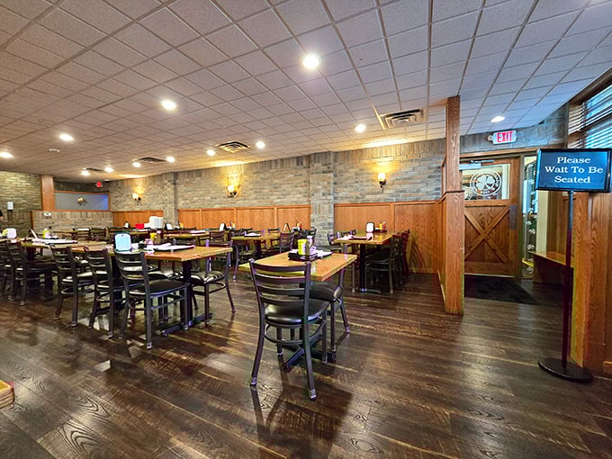 Wood paneling, stone accents, and that "Please Wait To Be Seated" sign – the universal language for "good things come to those who wait."