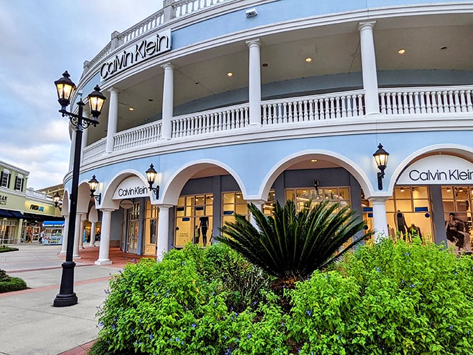 Calvin Klein's storefront embodies the outlet's elegant design philosophy—where bargain hunting happens beneath white columns that would make Thomas Jefferson nod in approval.