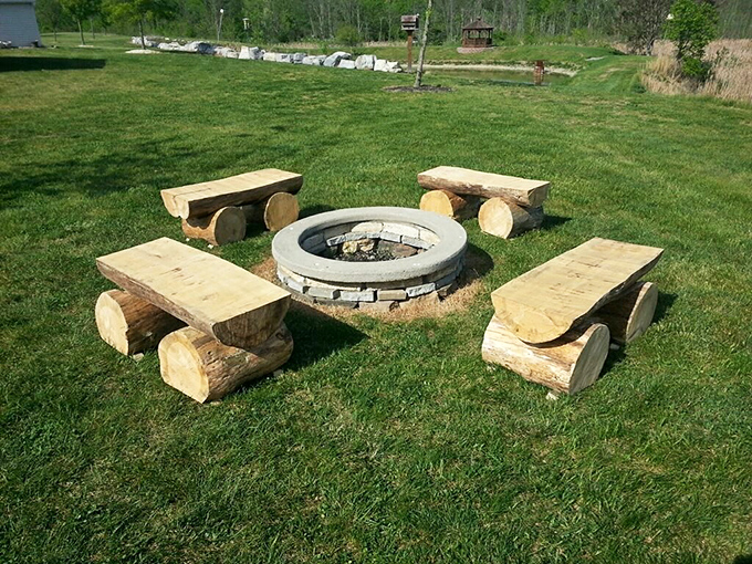 Rustic luxury at its finest – these handcrafted log benches surrounding a stone fire pit create the perfect spot for evening stories and marshmallow roasting.