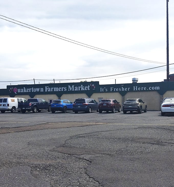 Rain or shine, the market's distinctive façade welcomes shoppers with its cheerful pink Q and promise of "It's Fresher Here."