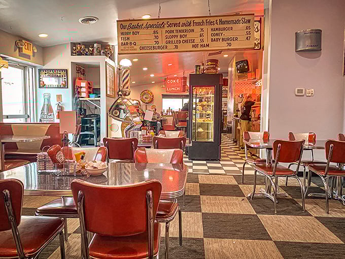 Classic Americana in its natural habitat—red vinyl chairs, checkered floors, and a menu board that promises zero culinary pretension.