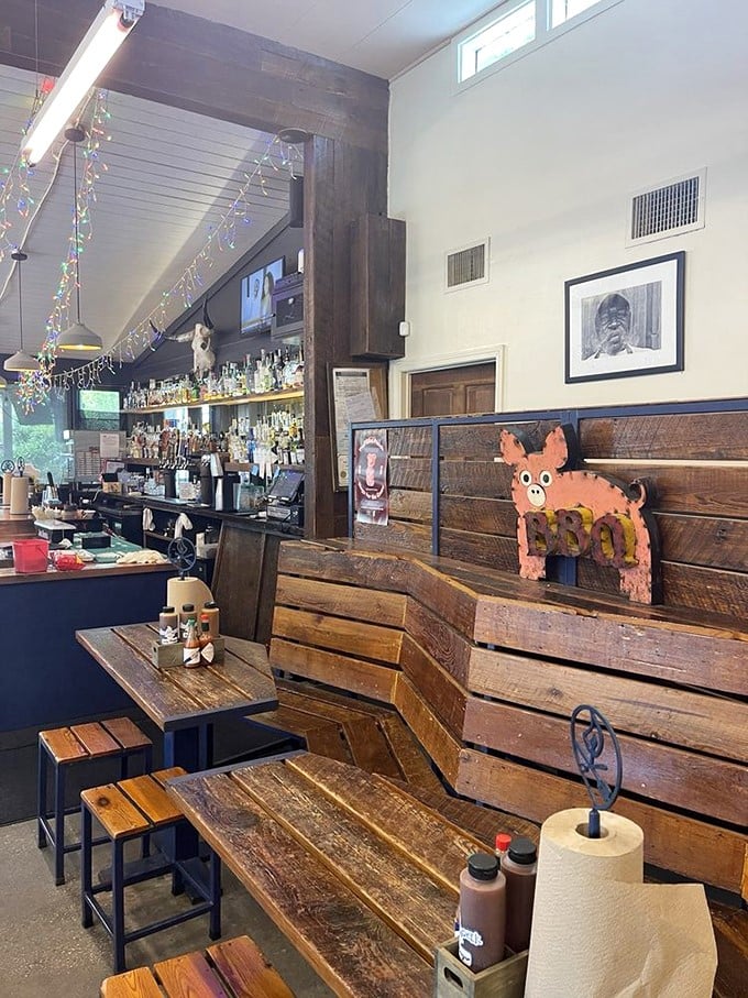 Rustic wooden tables and colorful string lights create the perfect backdrop for the serious business of devouring world-class barbecue.