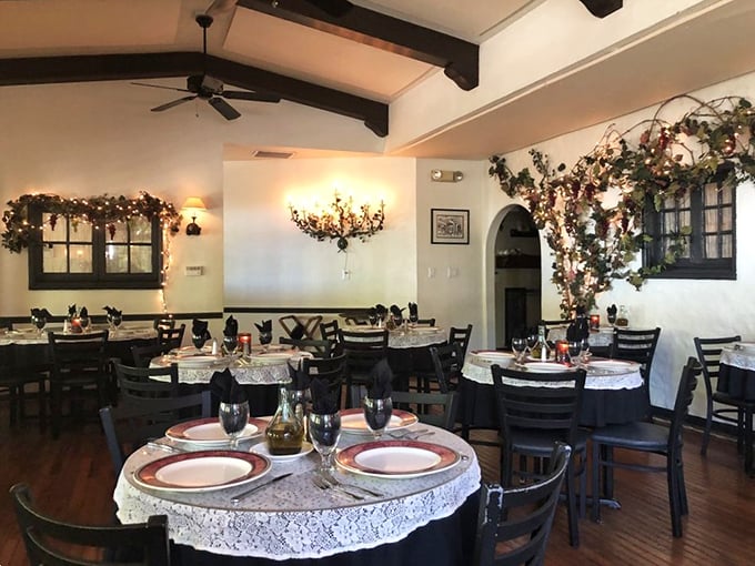 Exposed beams, vine-adorned walls, and elegant table settings transform this dining room into a Tuscan retreat that Diane Lane would approve of.