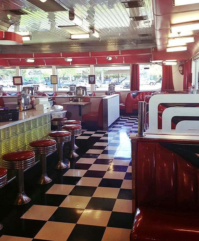 Step inside and time travel back to the golden age of diners—checkerboard floors, chrome accents, and those irresistibly spinnable red stools.