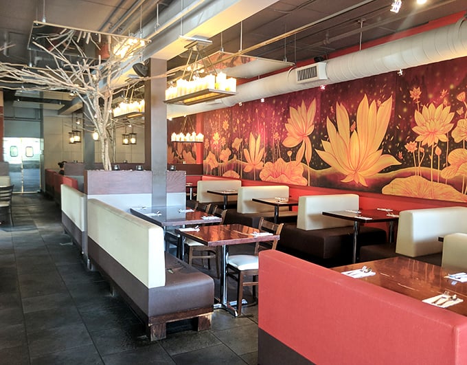 The dramatic lotus flower mural transforms an ordinary dining room into a Thai sanctuary. Those red booths have witnessed countless food epiphanies.