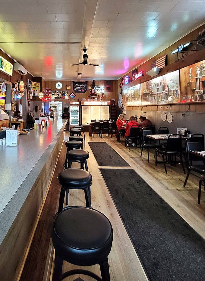 Step inside and time stands still – wood paneling, neon beer signs, and counter seating create the perfect backdrop for food that transcends its humble surroundings.