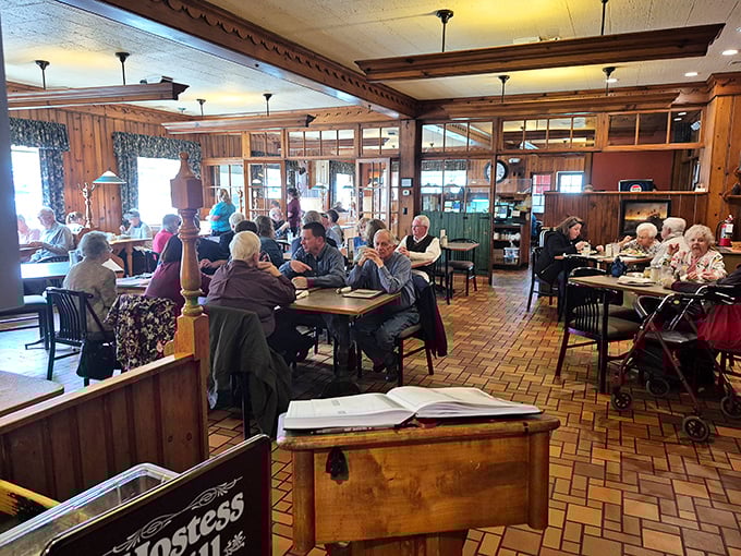 The bustling dining room with its warm wood paneling feels like a community living room where generations of locals gather.