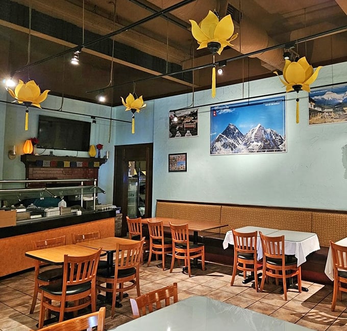 Yellow lotus flower lights hover above diners like culinary guardian angels. The mountain photos remind you this isn't just dinner—it's an expedition.