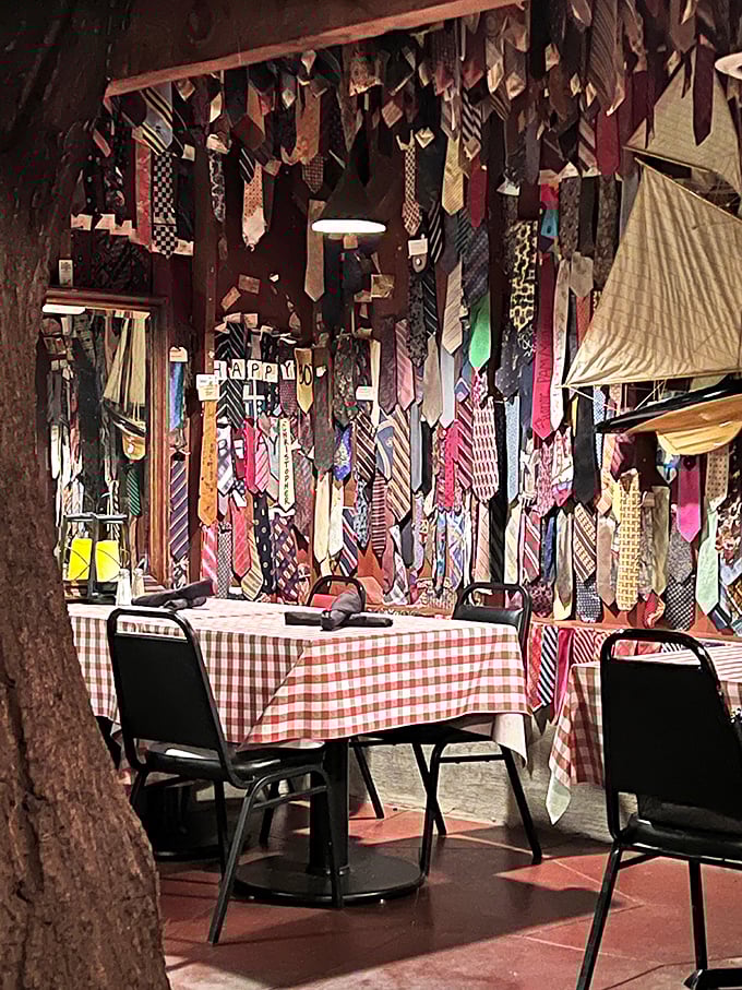 Hundreds of sacrificed neckties hang from the ceiling, each telling the story of a formal dress code left behind for steak nirvana.