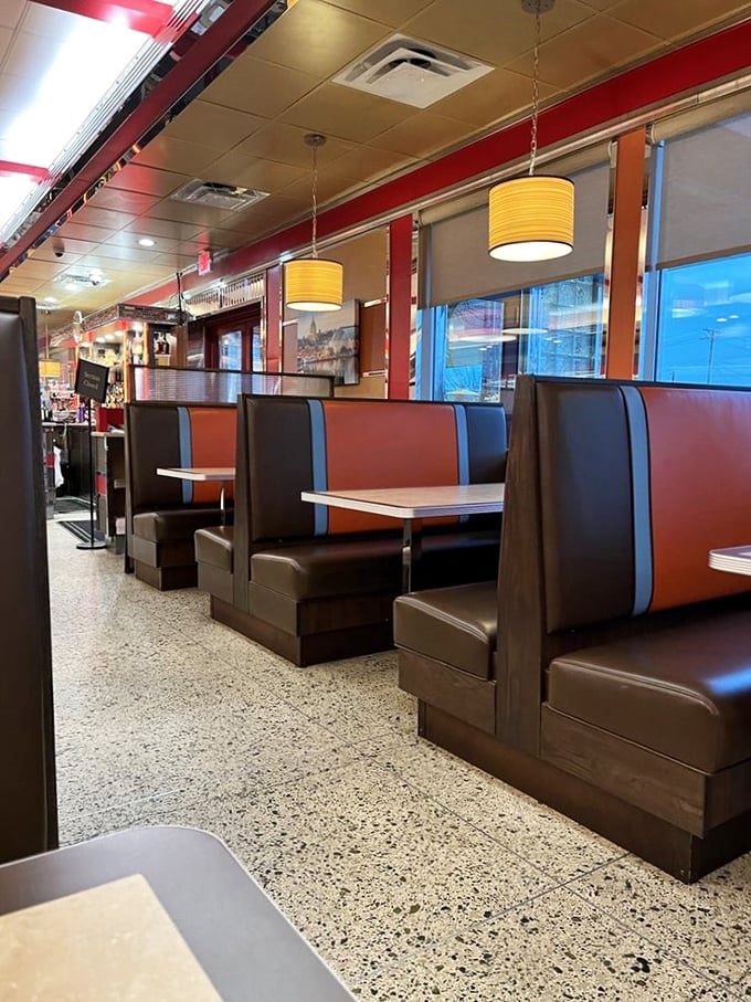 These burgundy and navy booths have witnessed countless first dates, family celebrations, and late-night philosophical discussions over endless coffee refills.