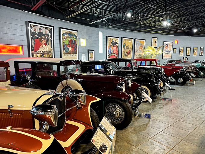 Vintage posters watch over these mechanical time travelers like proud parents. Each car tells a story of innovation that changed how we move through the world.
