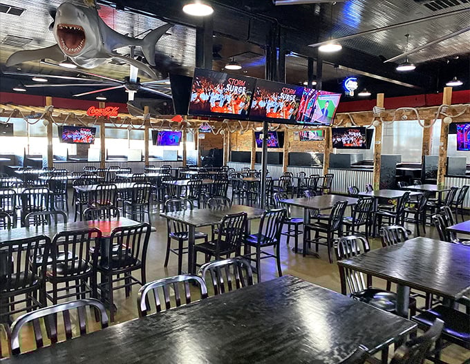 That menacing shark overhead sets the tone perfectly – you're entering waters where seafood reigns supreme and napkins surrender immediately.