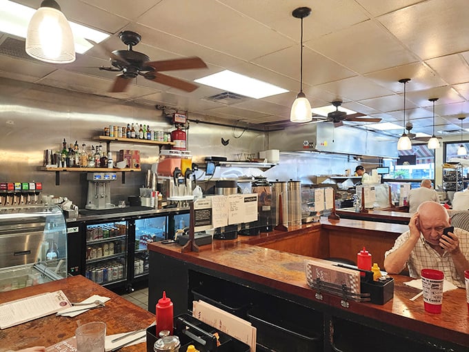 The classic horseshoe counter isn't just functional design – it's where strangers become neighbors and regulars become family over coffee refills.