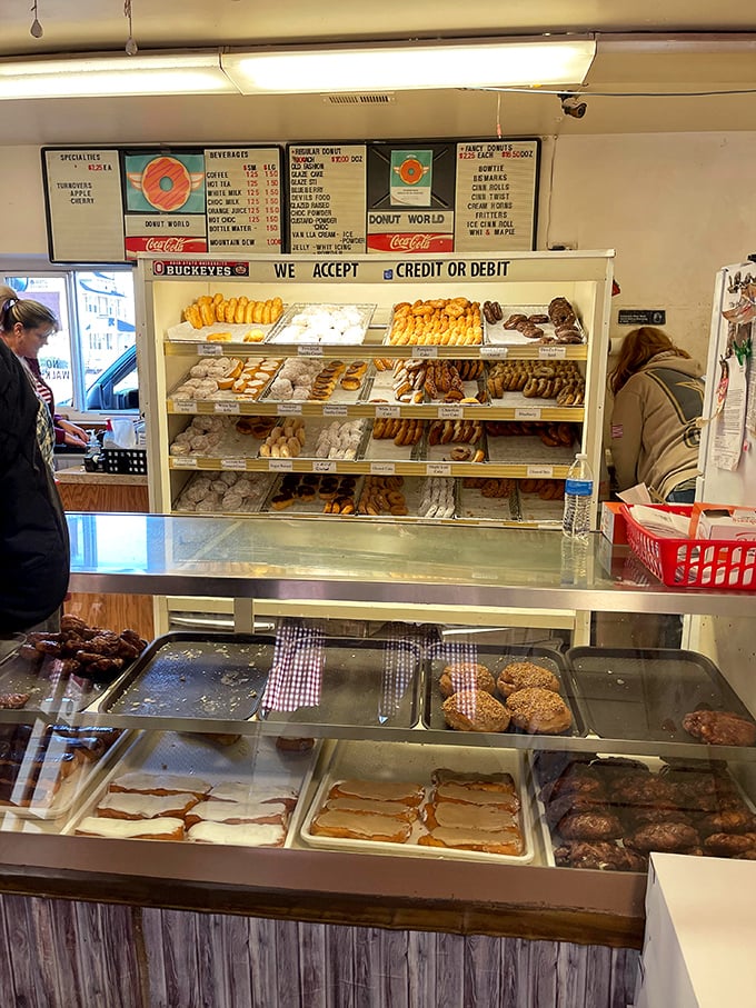 Behind this counter, magic happens. The display case showcases an edible art gallery where calories don't count and diet plans go to die.