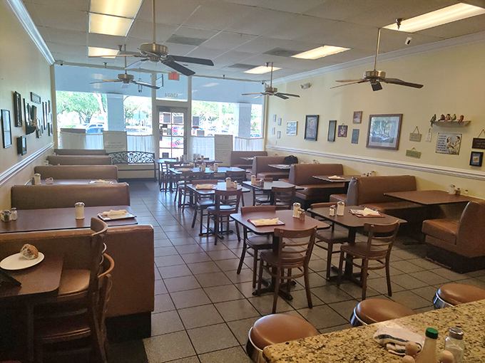 Ceiling fans lazily spin above brown vinyl booths where breakfast dreams come true. This isn't Instagram-bait decor; it's the real deal.