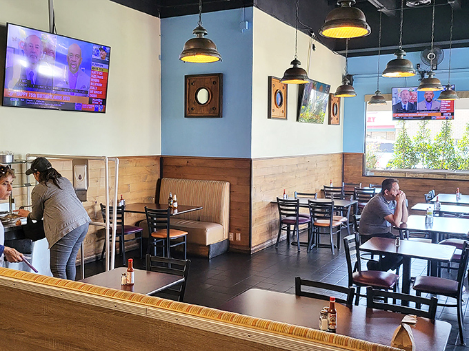 Blue walls, wooden accents, and pendant lighting create that perfect "neighborhood gem" atmosphere where comfort meets coastal cool.
