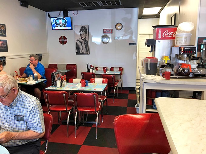 Step inside and the red vinyl booths, checkerboard floor, and Audrey Hepburn portrait tell you everything: time travel is possible, and it comes with coffee.