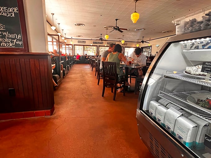 Inside, warm wood paneling and yellow pendant lights create that perfect diner atmosphere—where conversations flow as freely as the coffee refills.