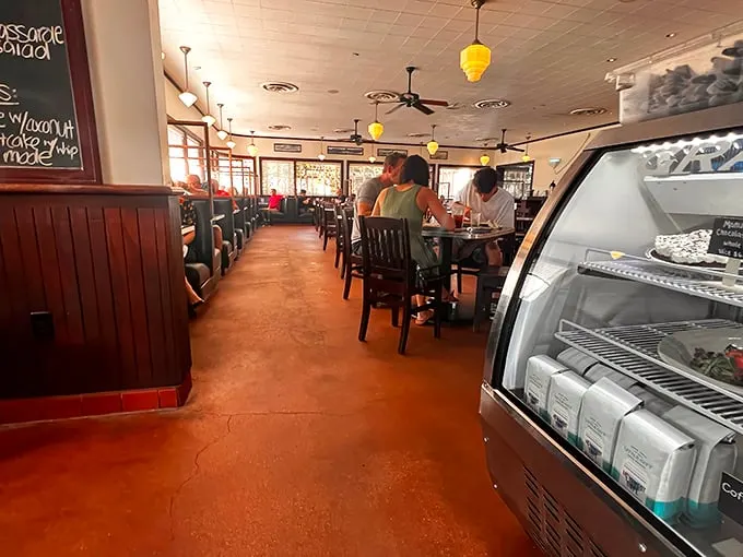 Inside, warm wood paneling and yellow pendant lights create that perfect diner atmosphere—where conversations flow as freely as the coffee refills.