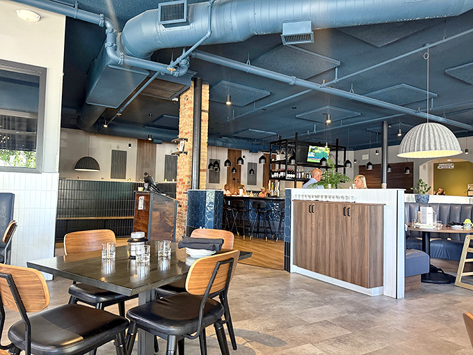 Industrial chic meets cozy comfort inside Taste, where exposed ductwork and warm wooden tables create the perfect backdrop for culinary exploration.