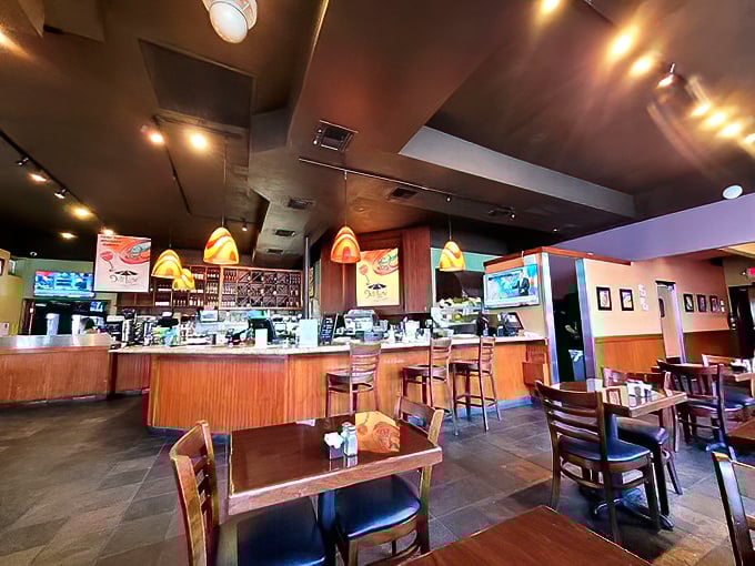 Warm wood tones and colorful pendant lights create that perfect "neighborhood joint" vibe—not too fancy, not too casual, just right for serious eating.