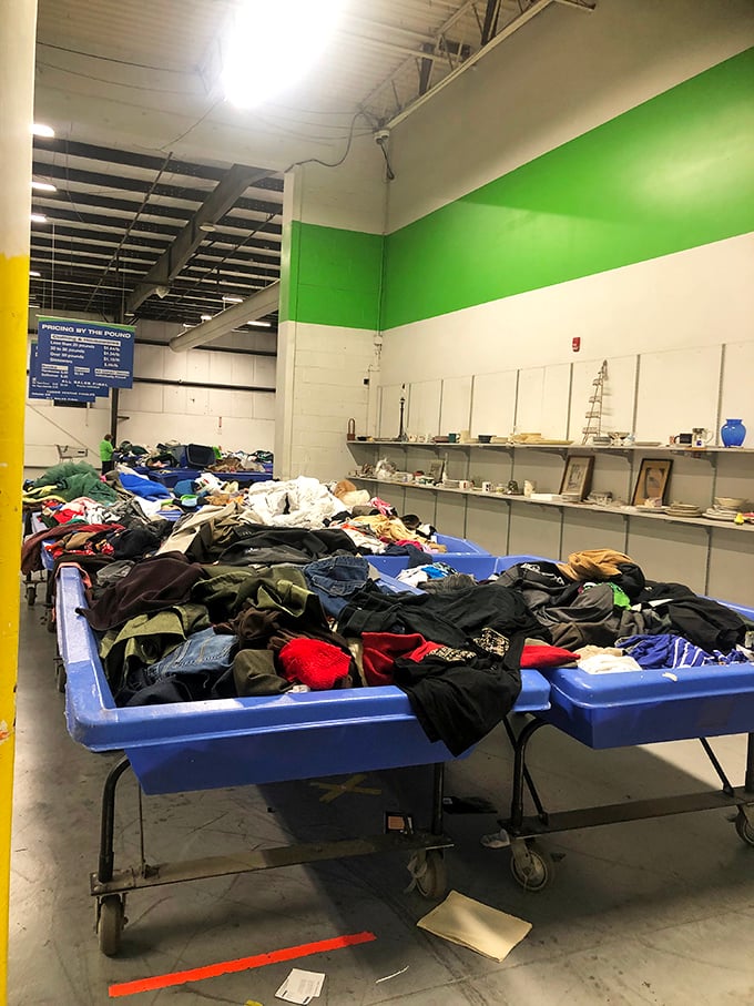 Blue bins as far as the eye can see! The outlet center entrance welcomes bargain hunters with a clear mission statement: find treasures, pay by the pound.