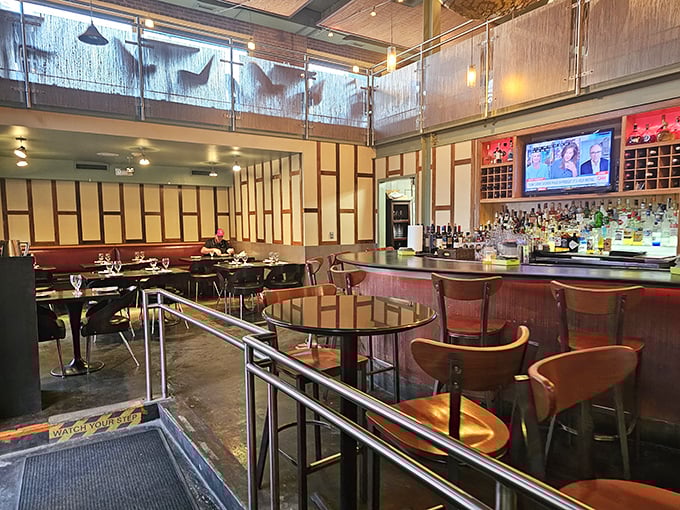 Step inside to a two-story oasis where modern design meets Thai tradition. That bar isn't just serving drinks—it's serving liquid happiness.