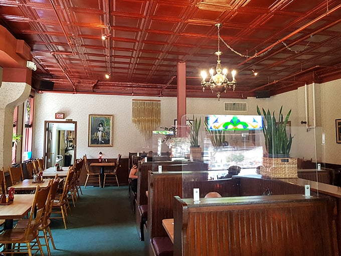 Beneath that gorgeous pressed tin ceiling, wooden booths invite you to settle in for a meal that feels like coming home—even if you've never been here before.