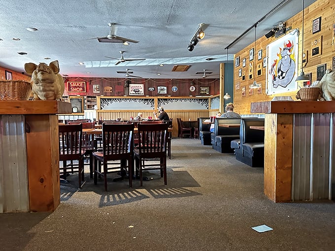 Wooden booths, corrugated metal, and pig memorabilia create the perfect backdrop for the serious business of barbecue appreciation.
