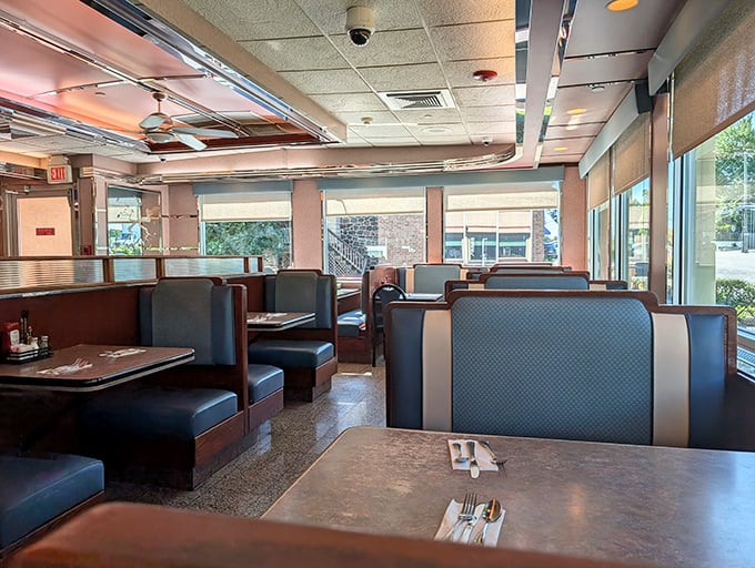 Blue vinyl booths and warm lighting create that perfect diner atmosphere—where important life decisions are made, like whether to order breakfast at 3 PM.