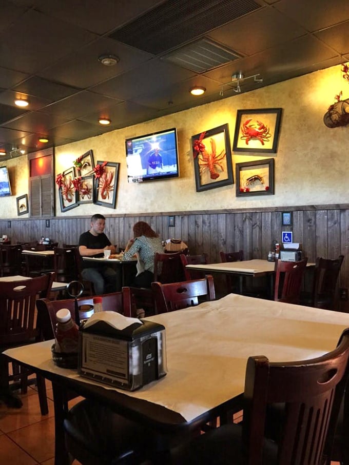 Wooden paneling meets seafood-themed artwork in this cozy interior where conversations flow as freely as the seafood sauces.