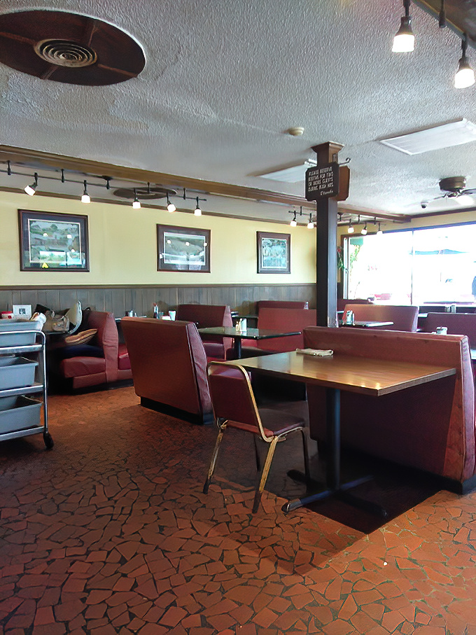 Burgundy booths and yellow walls create that perfect diner atmosphere where conversations flow as freely as the coffee refills.