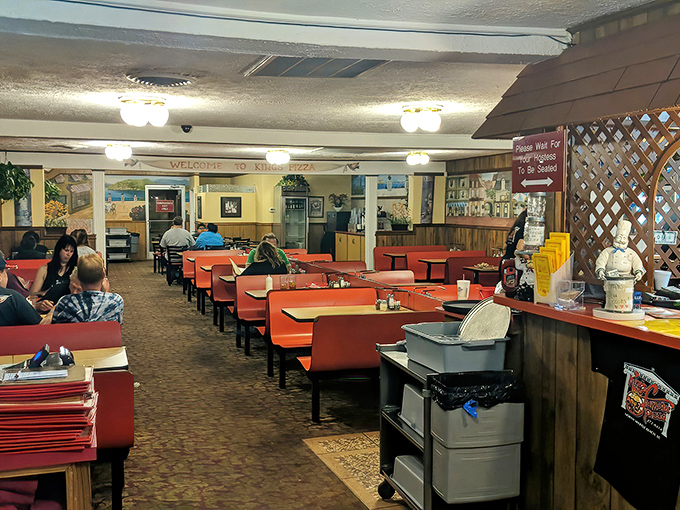 Inside, those classic orange booths aren't trying to impress Instagram—they're promising comfort while you focus on what really matters: the food.