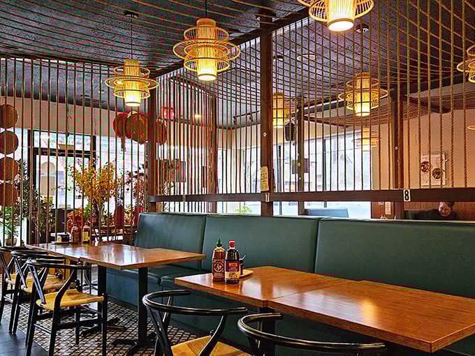 Step inside and bamboo-themed pendant lights cast a warm glow over green booths and wooden tables, creating the perfect backdrop for your soon-to-be favorite meal.
