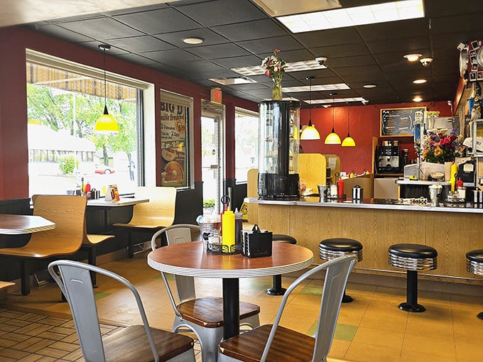 Red walls, yellow pendant lights, and that unmistakable diner energy – stepping inside feels like entering a time capsule where comfort reigns supreme.