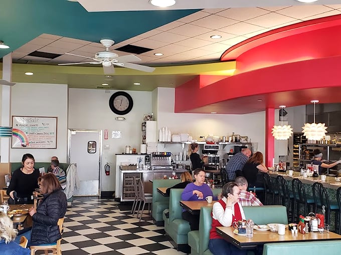 The vibrant interior feels like a breakfast party where everyone's invited—teal, red, and yellow create the perfect morning mood.