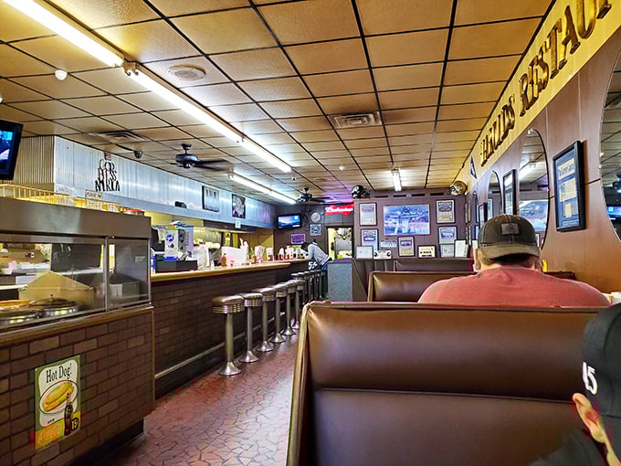 Classic brown vinyl booths and counter seating create that perfect diner atmosphere where conversations flow as freely as the coffee.
