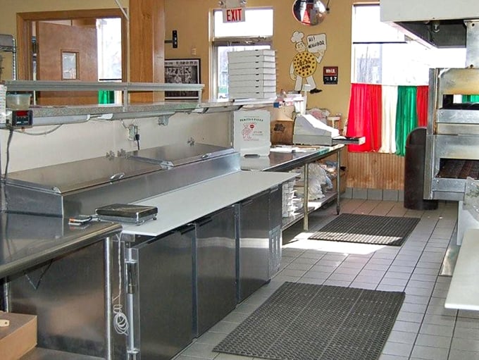 Behind the counter, where culinary magic happens without fanfare. This no-nonsense workspace has likely witnessed decades of dough-tossing expertise.