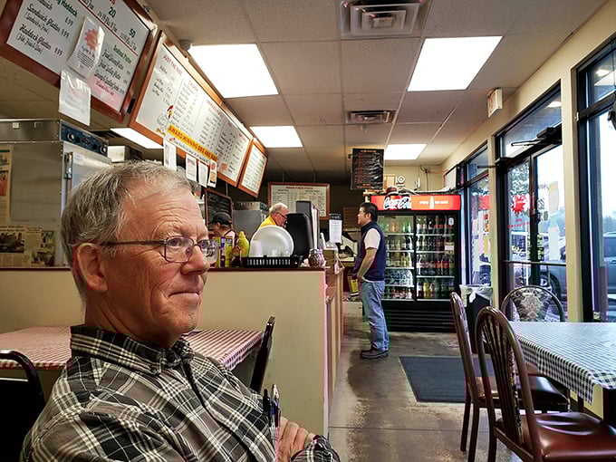 The interior view reveals the heart of BBQ operations—where hungry patrons line up for smoky treasures while menus tempt from above.