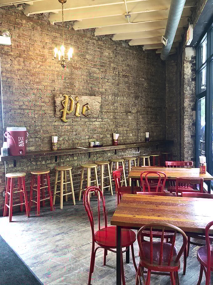 Exposed brick walls, red chairs, and that golden "Pie" sign – minimalism never tasted so good. The industrial-chic vibe is just the appetizer.