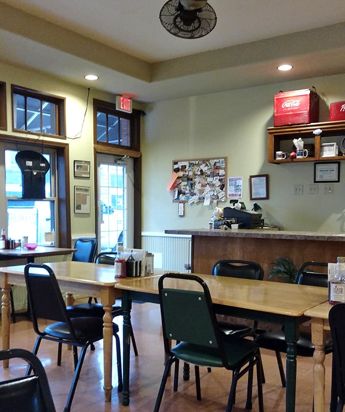 Simple wooden tables, comfortable chairs, and a bulletin board full of community notices—this is where Mena gathers to break bread and share stories.