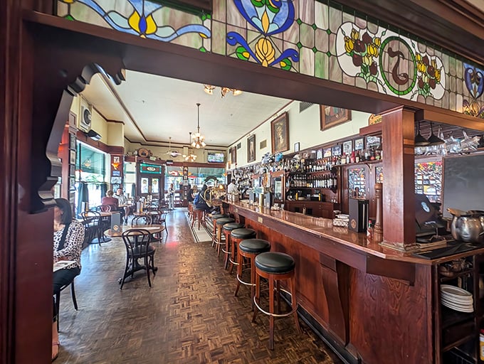 The bar at Jake's is where time stands still – stained glass above, polished wood below, and cocktails that make you forget what century you're in.