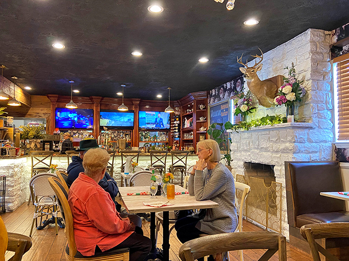 Inside, rustic elegance meets cozy comfort. That mounted deer isn't judging your order—he's just jealous he can't try the shrimp and grits.