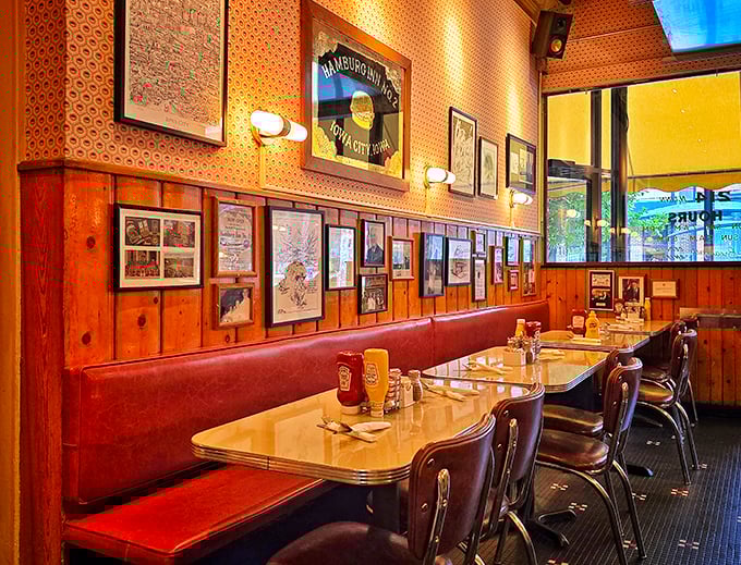 Step inside and time travel begins—wood paneling, red vinyl booths, and walls of memories create the diner atmosphere that chain restaurants spend millions trying to replicate.
