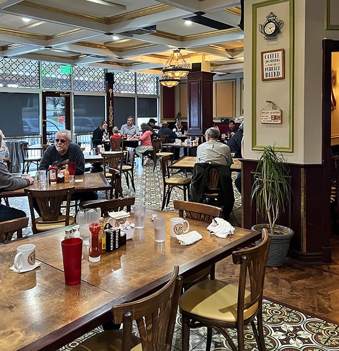 Inside, the coffered ceiling, elegant chandeliers, and patterned floor create an atmosphere that says "stay awhile" – and most patrons happily oblige.