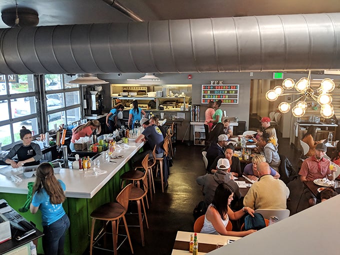 Inside, industrial chic meets neighborhood warmth as diners gather around the distinctive bar. Those exposed ducts aren't just for show—they're ventilating pure breakfast joy.