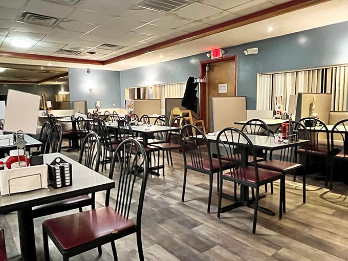 Simple tables, comfortable chairs, and that unmistakable blue-walled warmth—this isn't interior design, it's a comfort food sanctuary where conversations flow as freely as the coffee.