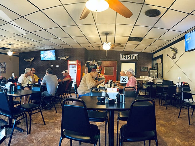 Inside, the "LETSEAT" sign isn't just decoration—it's practically the town motto. Simple tables, ceiling fans, and conversations that flow as freely as the coffee.